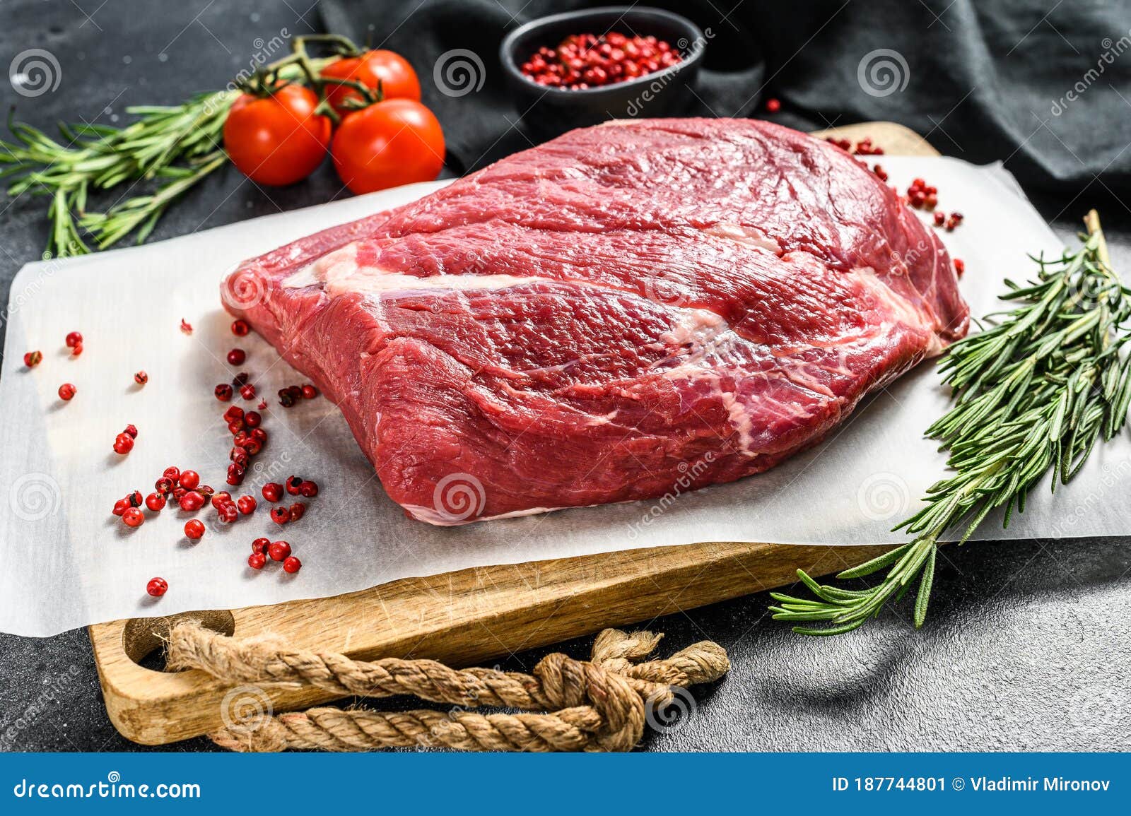 Raw Round Beef Cut on a Cutting Board. Black Background Stock Image ...