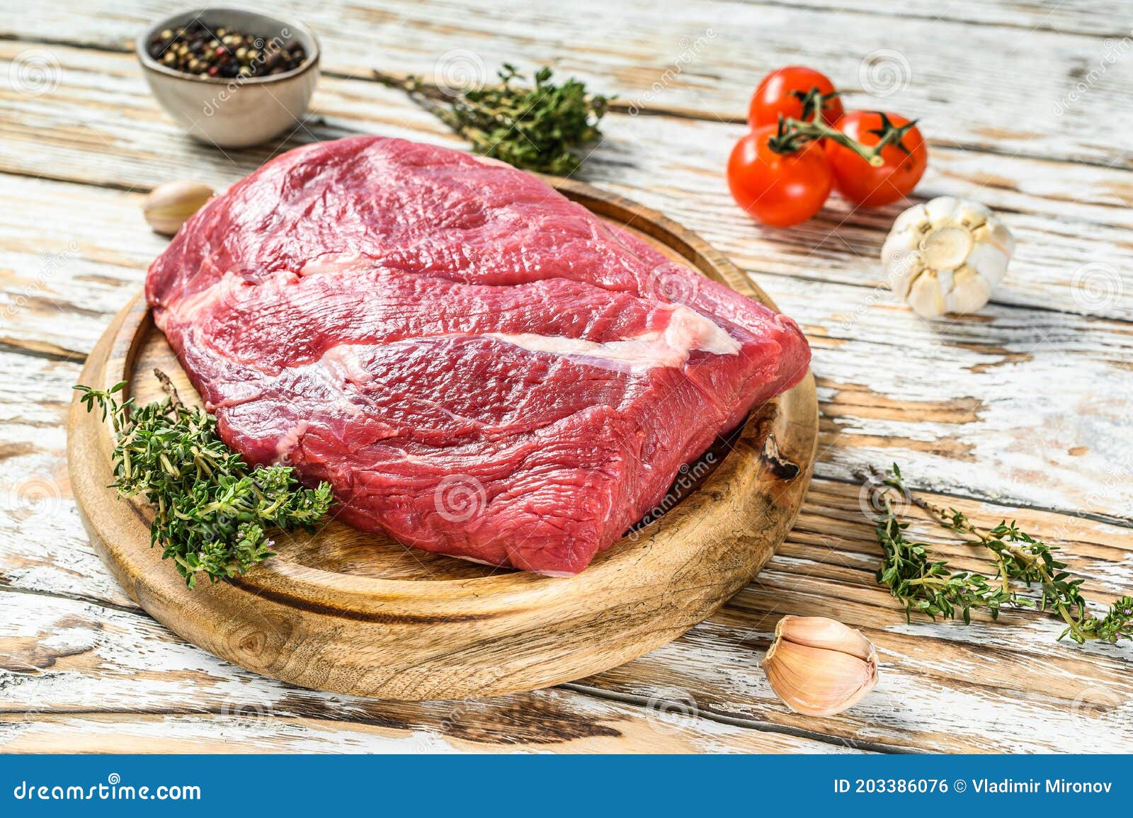 Raw Round Beef Cut on a Wooden Board. White Background Stock Photo ...