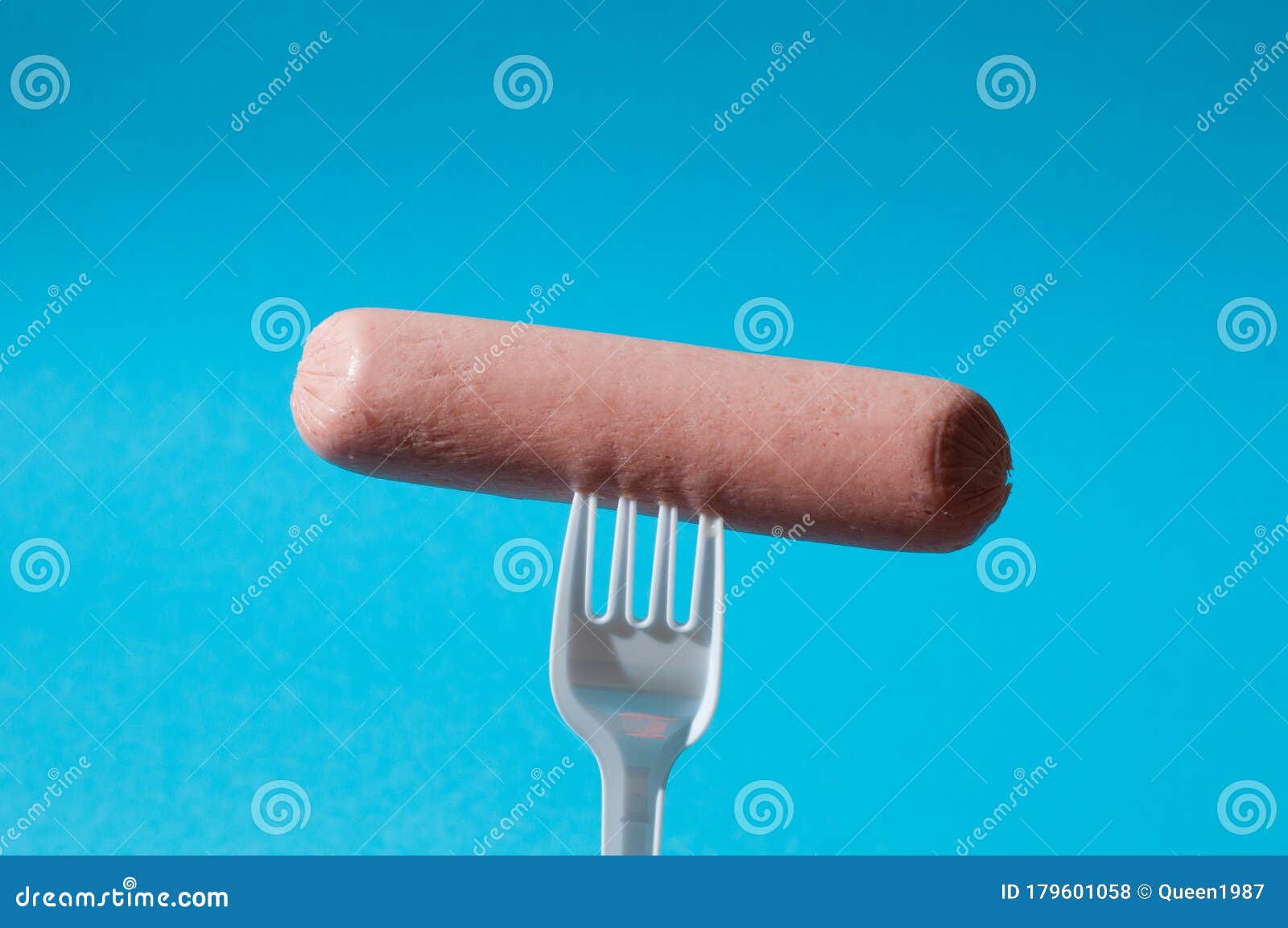 Raw Sausage on a Blue Background with a Plastic Fork Stock Photo ...