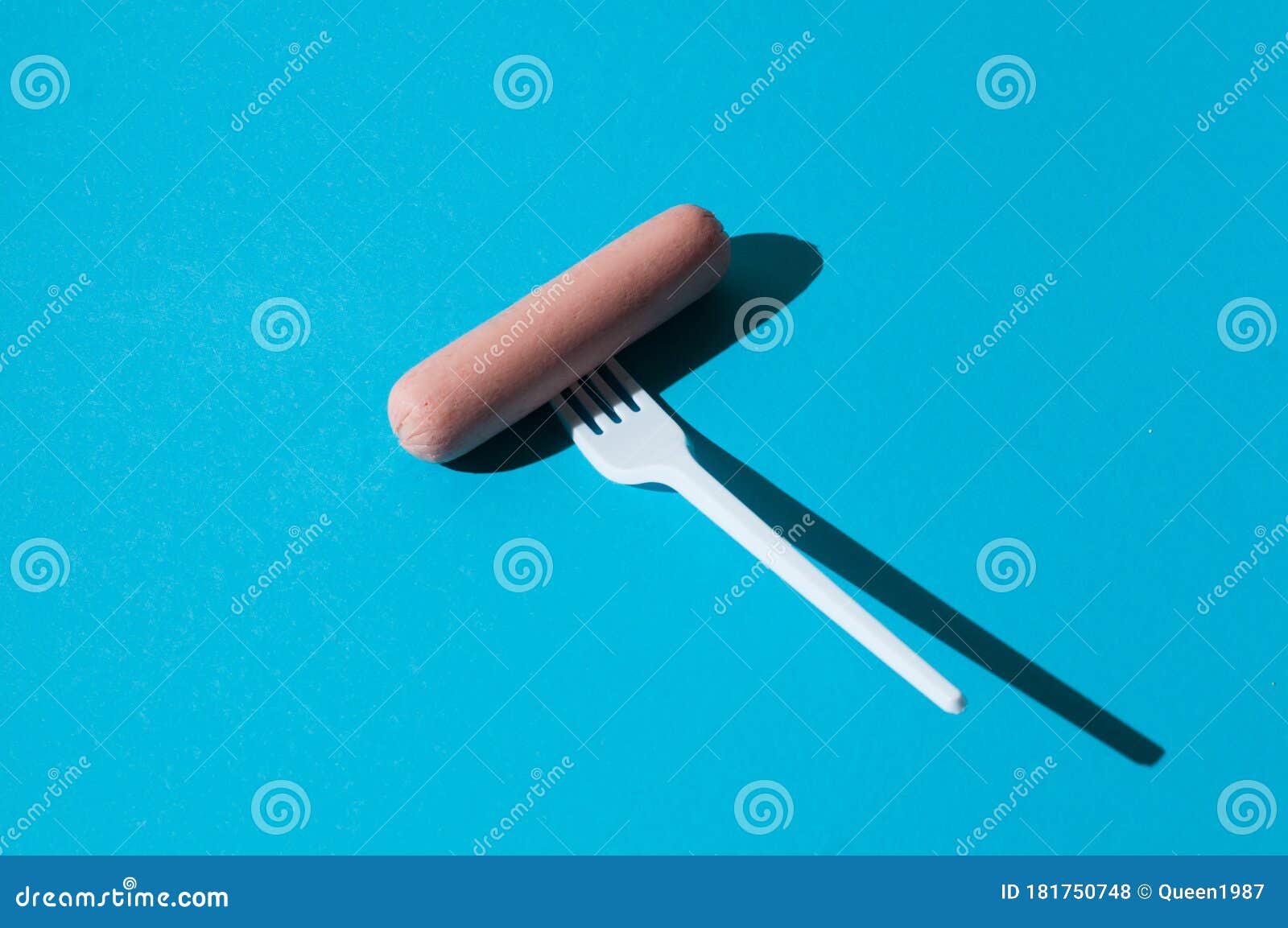 Raw Sausage on a Blue Background with a Plastic Fork Stock Photo ...