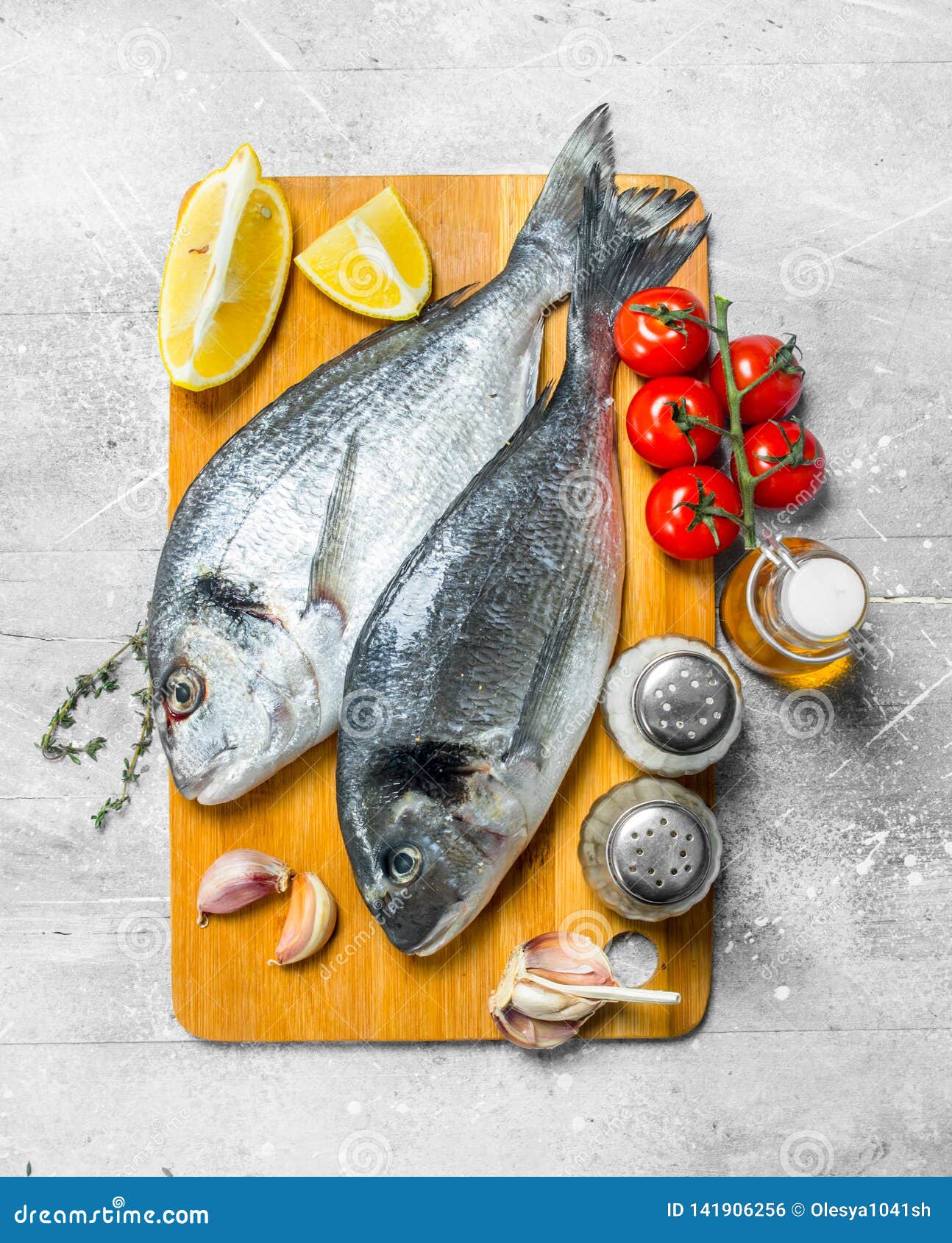 Raw Sea Fish Dorado with Tomatoes, Lemon Wedges and Spices Stock Photo ... Raw Sea Fish Dorado with Tomatoes, Lemon Wedges and Spices Stock Photo ...