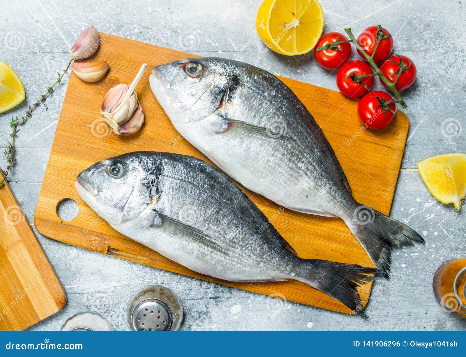 Raw Sea Fish Dorado with Tomatoes, Lemon Wedges and Spices Stock Photo ... Raw Sea Fish Dorado with Tomatoes, Lemon Wedges and Spices Stock Photo ...