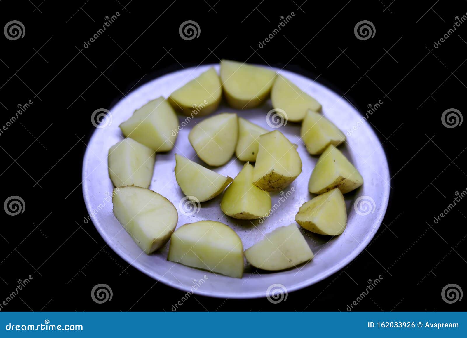 Raw Sliced Potato of Plate Isolated on Black Background Stock Photo ...