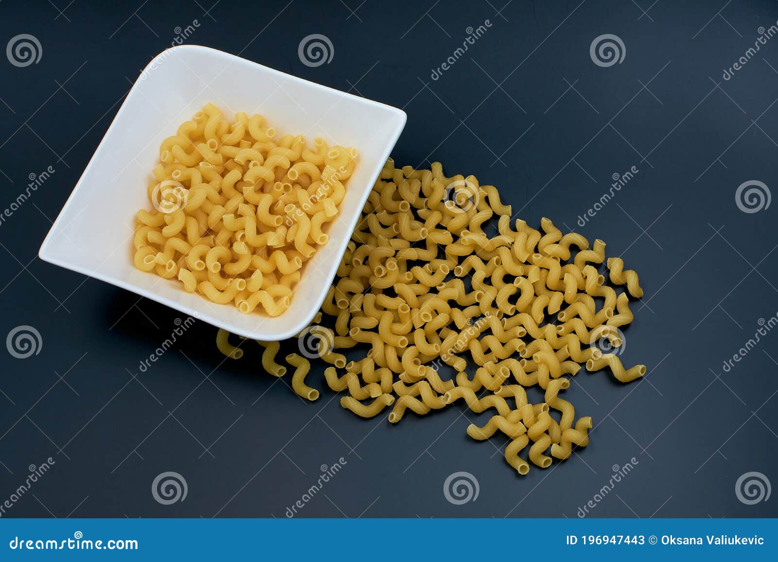 Raw Small Pasta in the Shape of a Spring. Pasta in a White Plate on a ...