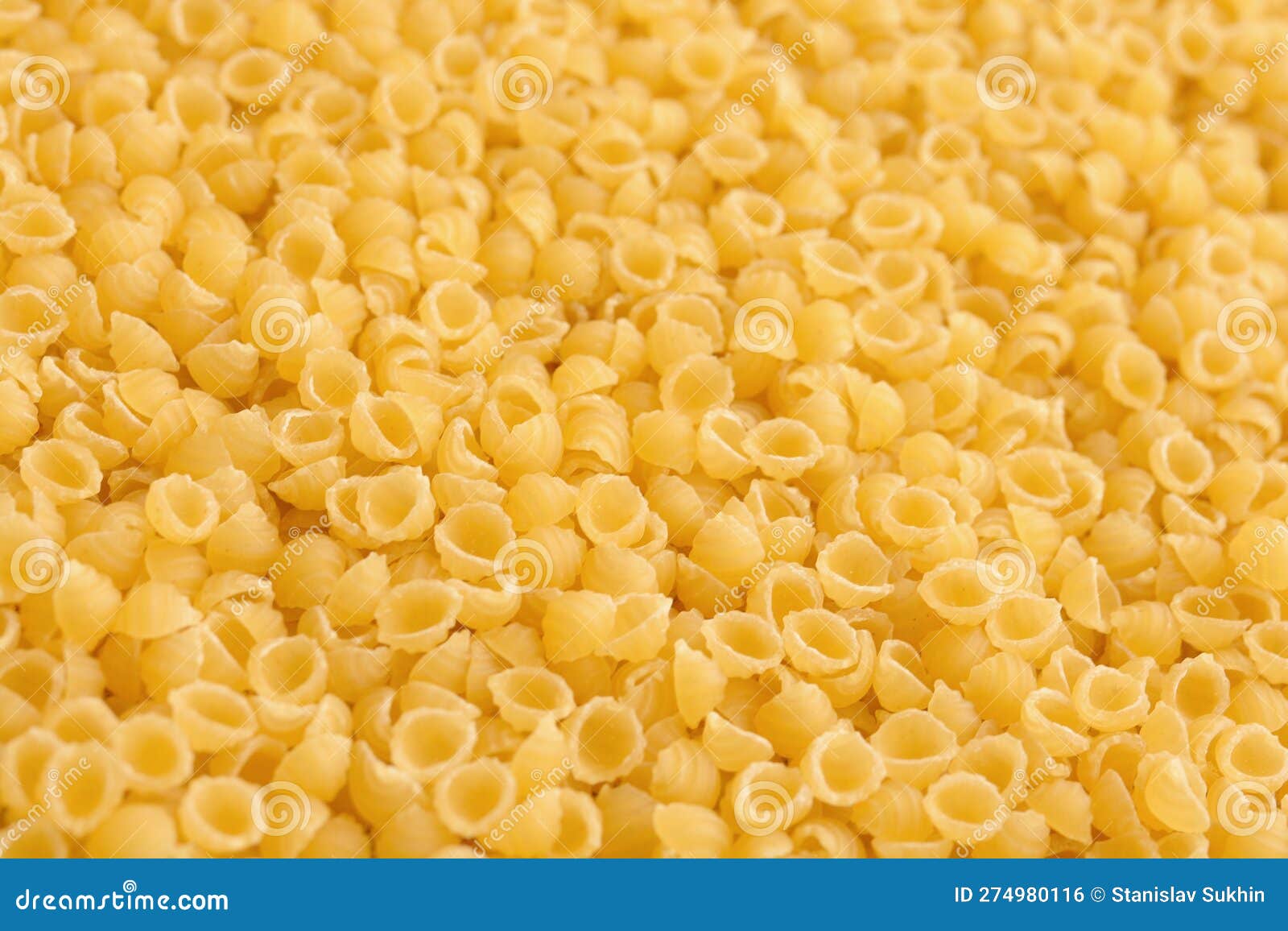 Raw Small Pasta In The Shape Of A Spring. Pasta In A White Plate On A ...