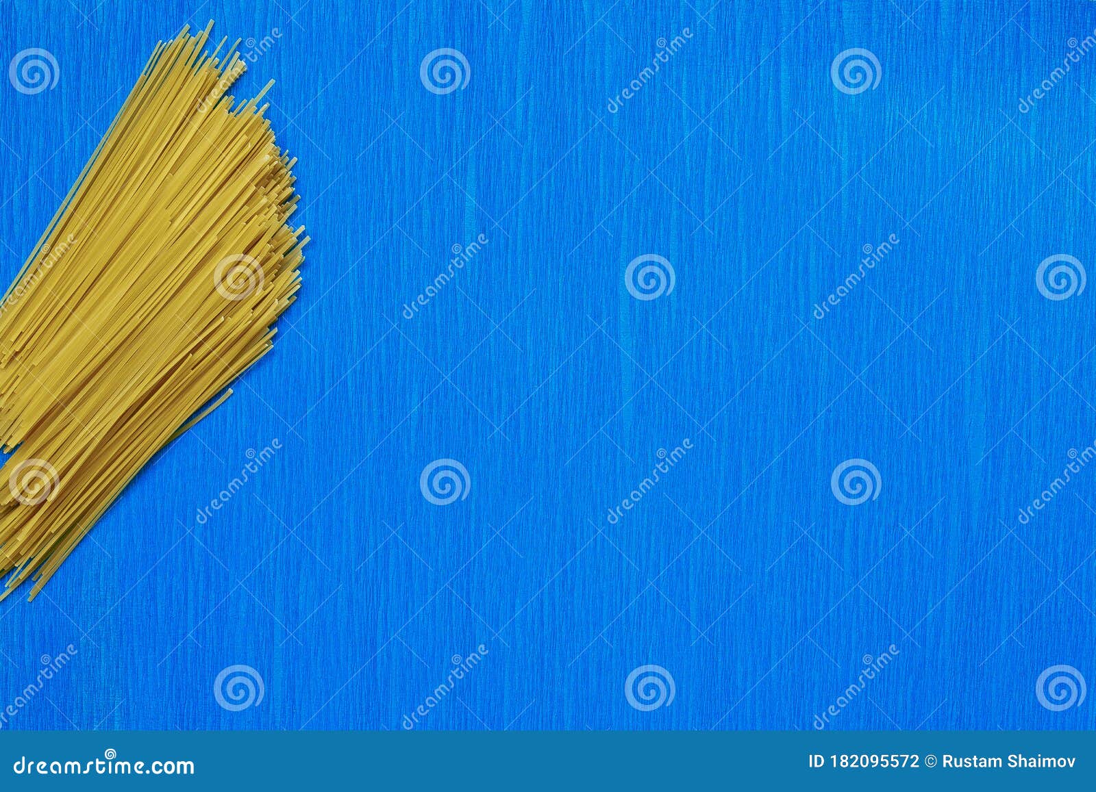 Raw Spaghetti Pasta on Blue Background. Stock Photo - Image of ...