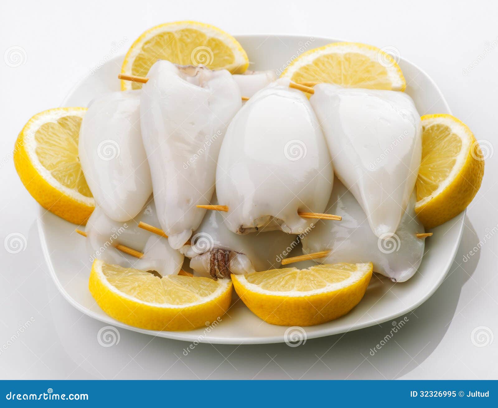Raw Squid Ready To Be Cooked in Plate and Cut Lemons Stock Image ...