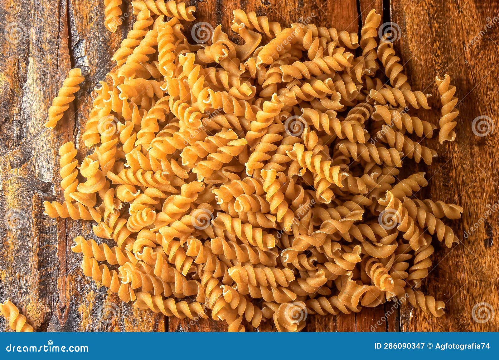 Raw Whole Grain Fusilli Pasta on Rustic Wooden Kitchen Table Stock ...