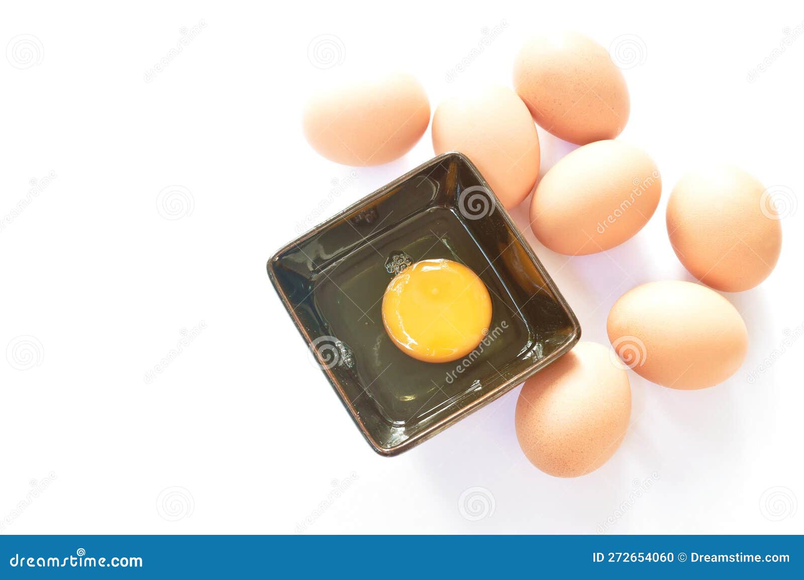 Raw Yolk and White Egg Cracked from Shell in Cup on White Background ...