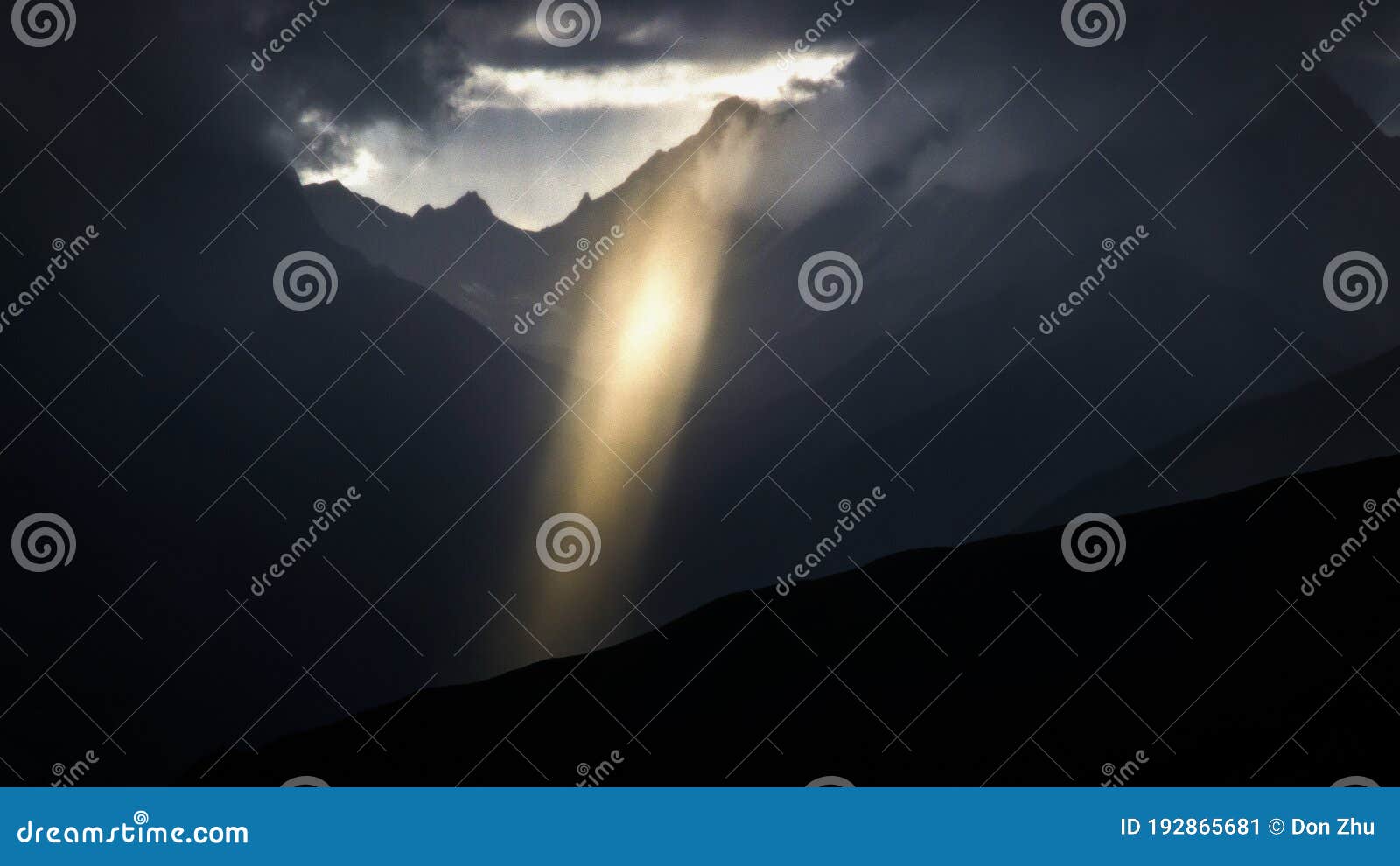 A Ray of Gold Light Shines from the Clouds and Shines in the Mountains ...
