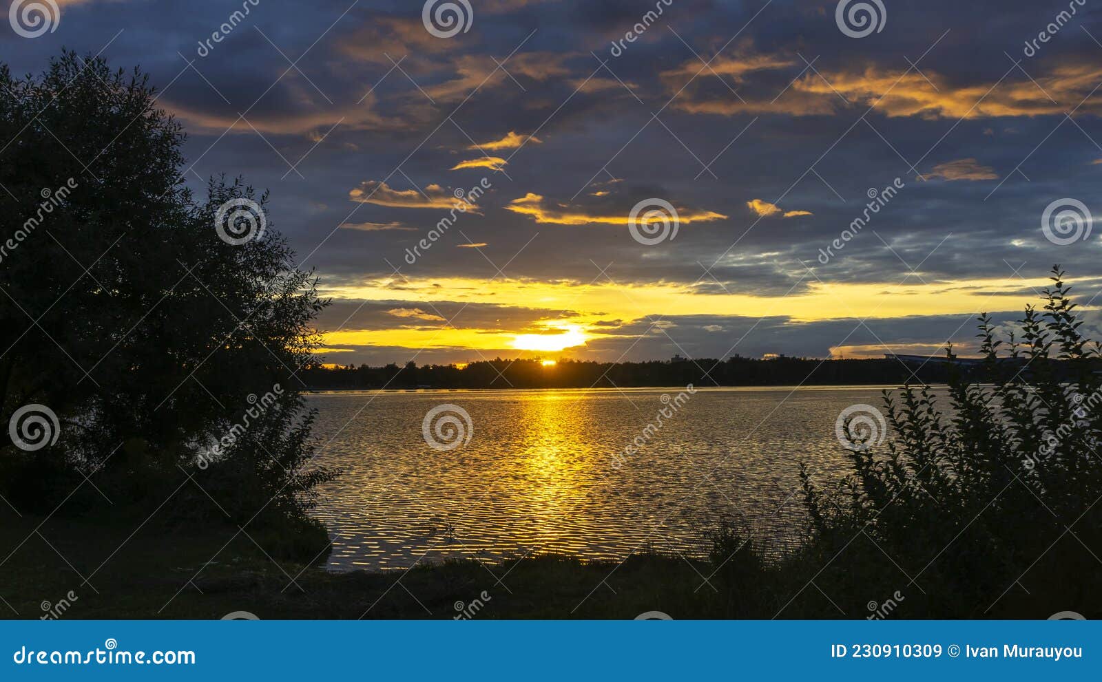 The Rays of the Dawn Sun on the Lake. Reflection of Sunset Clouds in ...