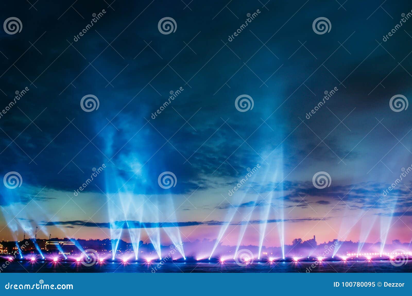 Rays of Light Directed Up the Sky at Night in the City. Stock Image ...