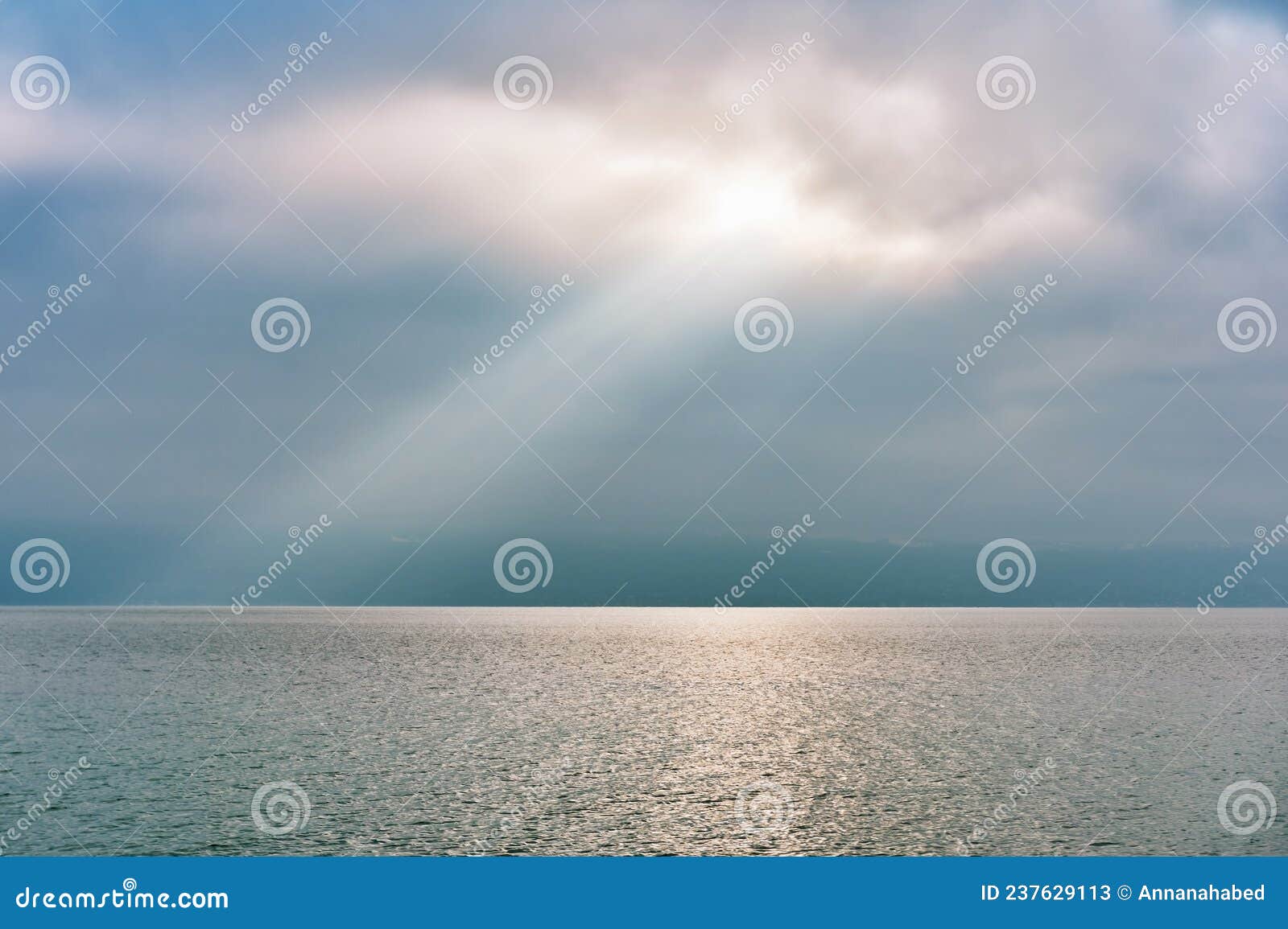 Rays of Light Falling through Clouds on Calm Water Stock Image - Image ...