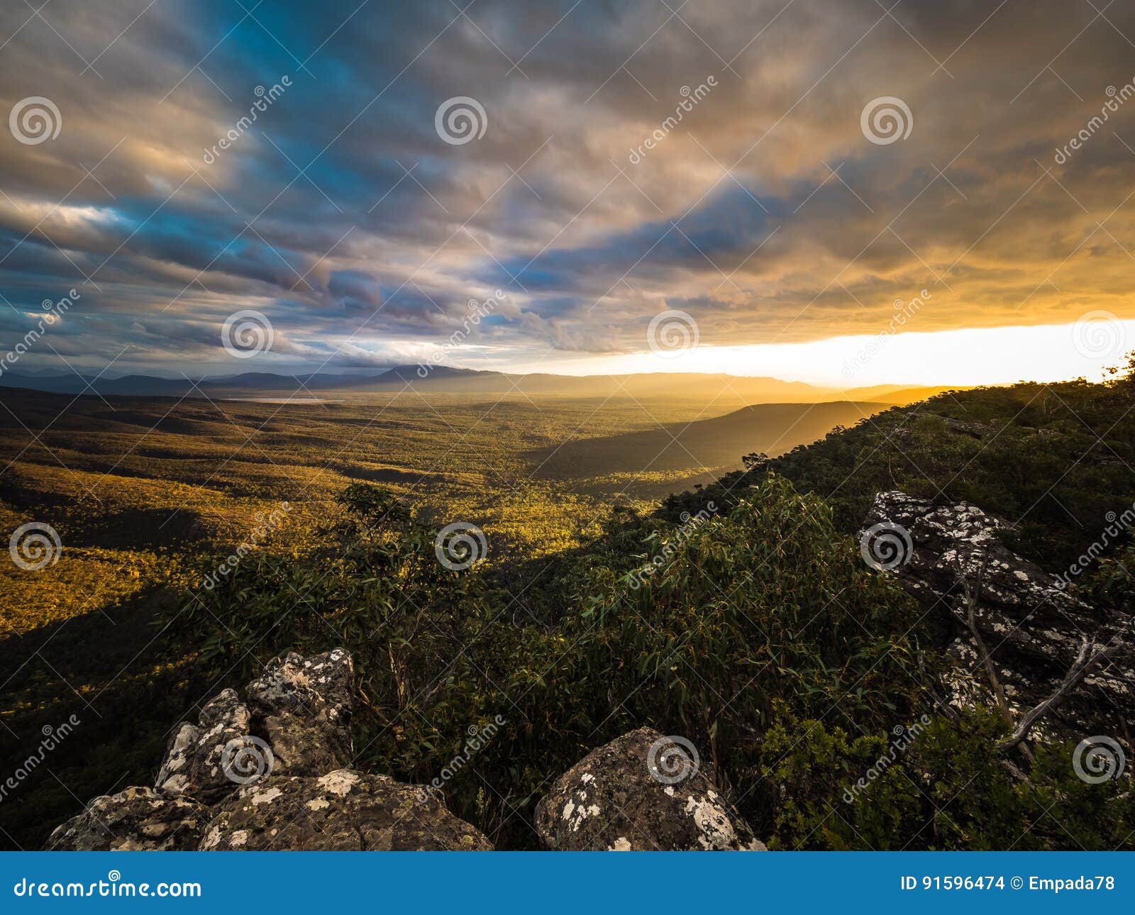 Rays of Light from Setting Sun Over Mountain Valley Stock Photo - Image ...