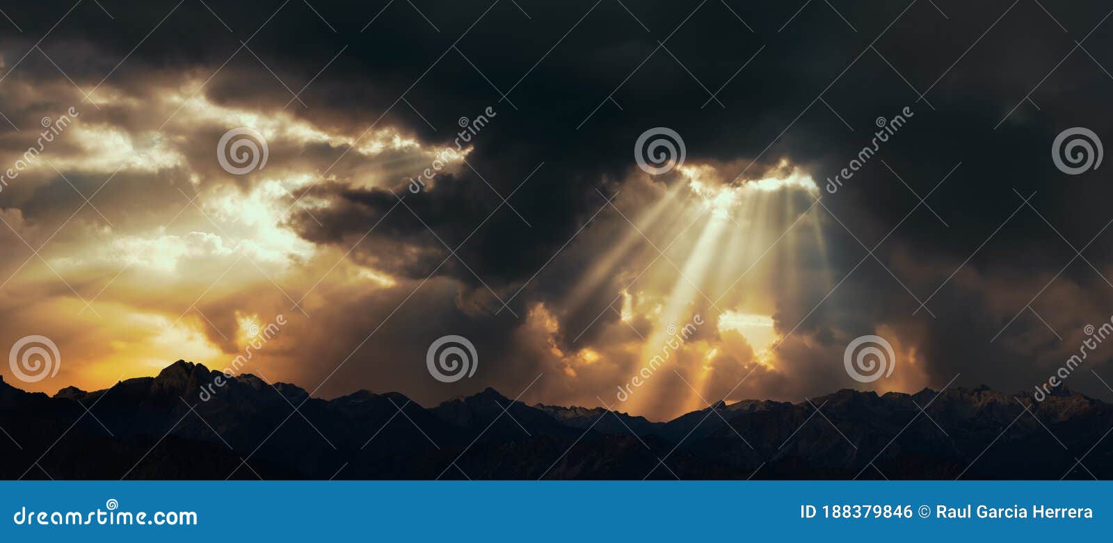 Rays of Light Shining through Dark Clouds Over Mountains. Cinematic ...