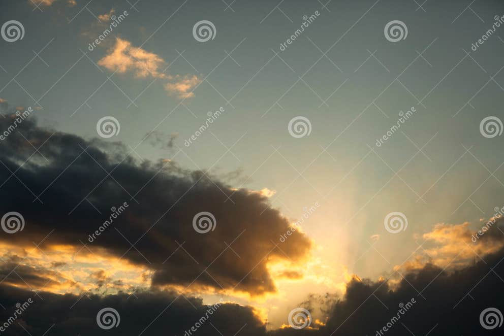 The Rays of the Setting Spring Sun Break through the Gray Storm Clouds ...