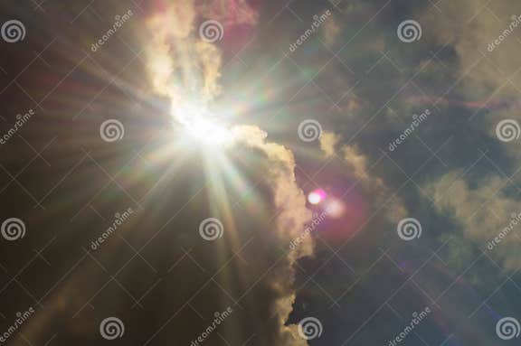 The Rays of the Sun Break through from the Edge of a Huge Dark Cloud, Spreading in Different ...