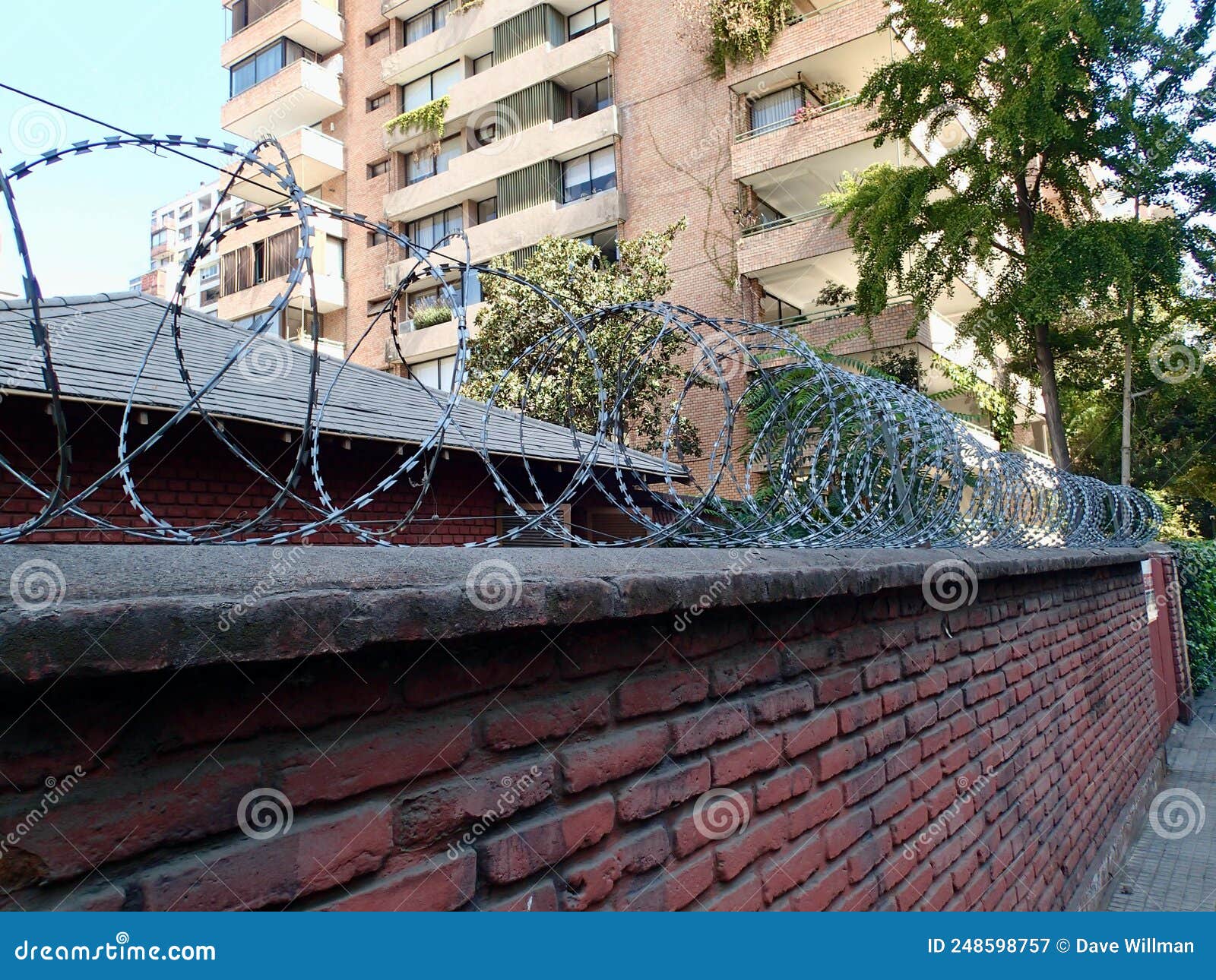 Razor wire on a brick wall stock image. Image of brick - 248598757