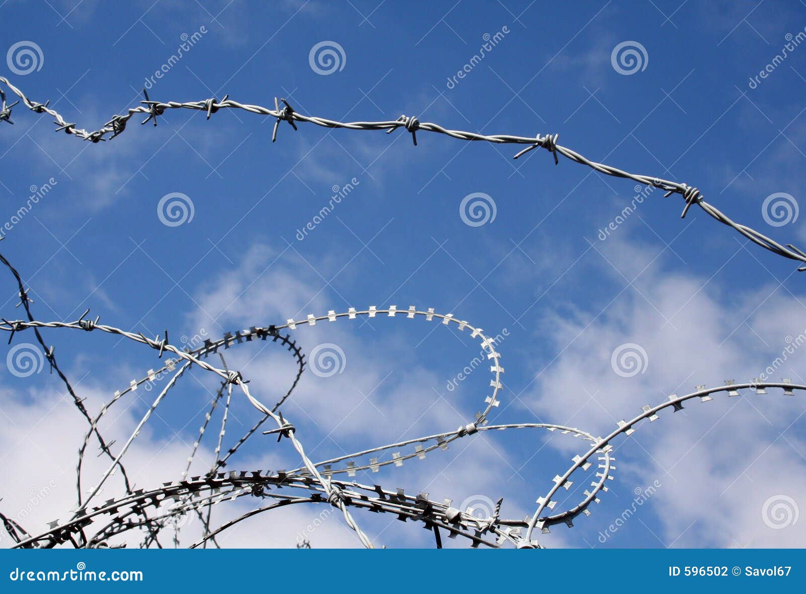 Razor wire clouds stock photo. Image of wire, freedom, detained - 596502