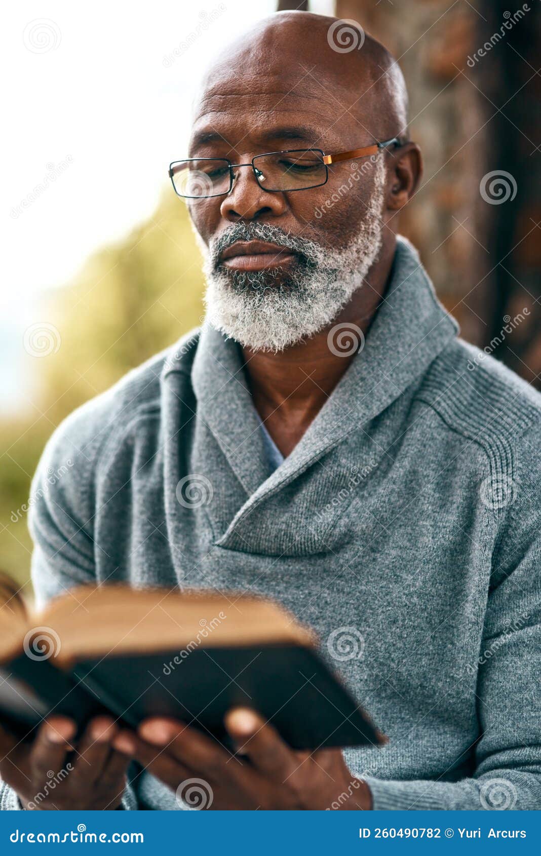 Read More, Worry less. a Man Reading a Book Outside. Stock Photo ...
