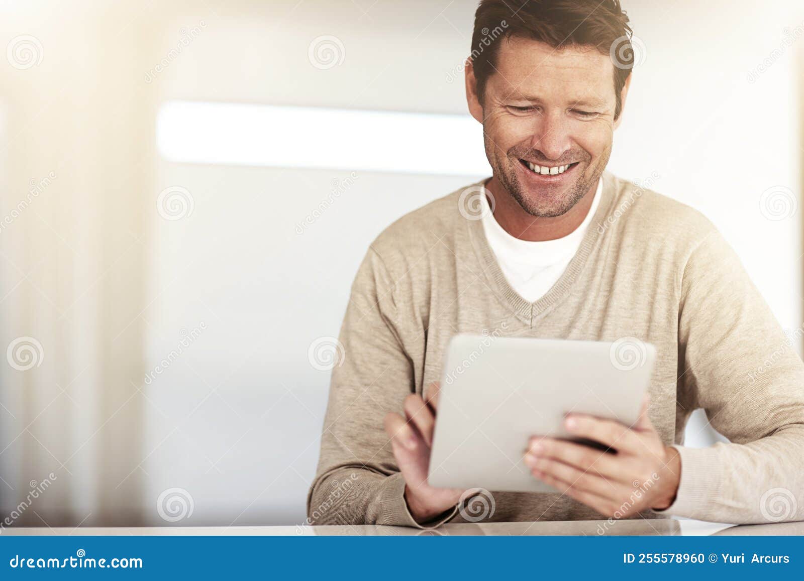 Reading an Amusing Email. a Man Using His Tablet at Home. Stock Photo ...