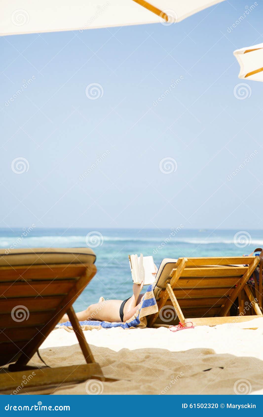 Reading book on the beach stock photo. Image of beach - 61502320