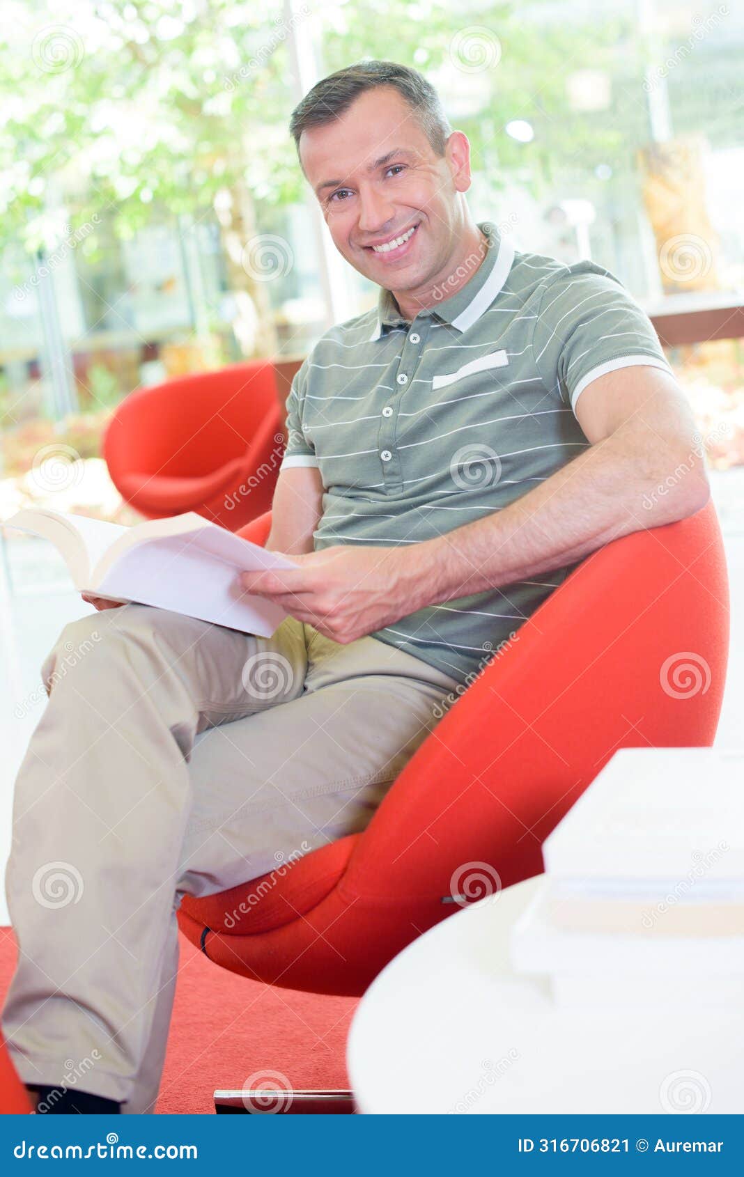 Reading book in fancy seat stock image. Image of pose - 316706821