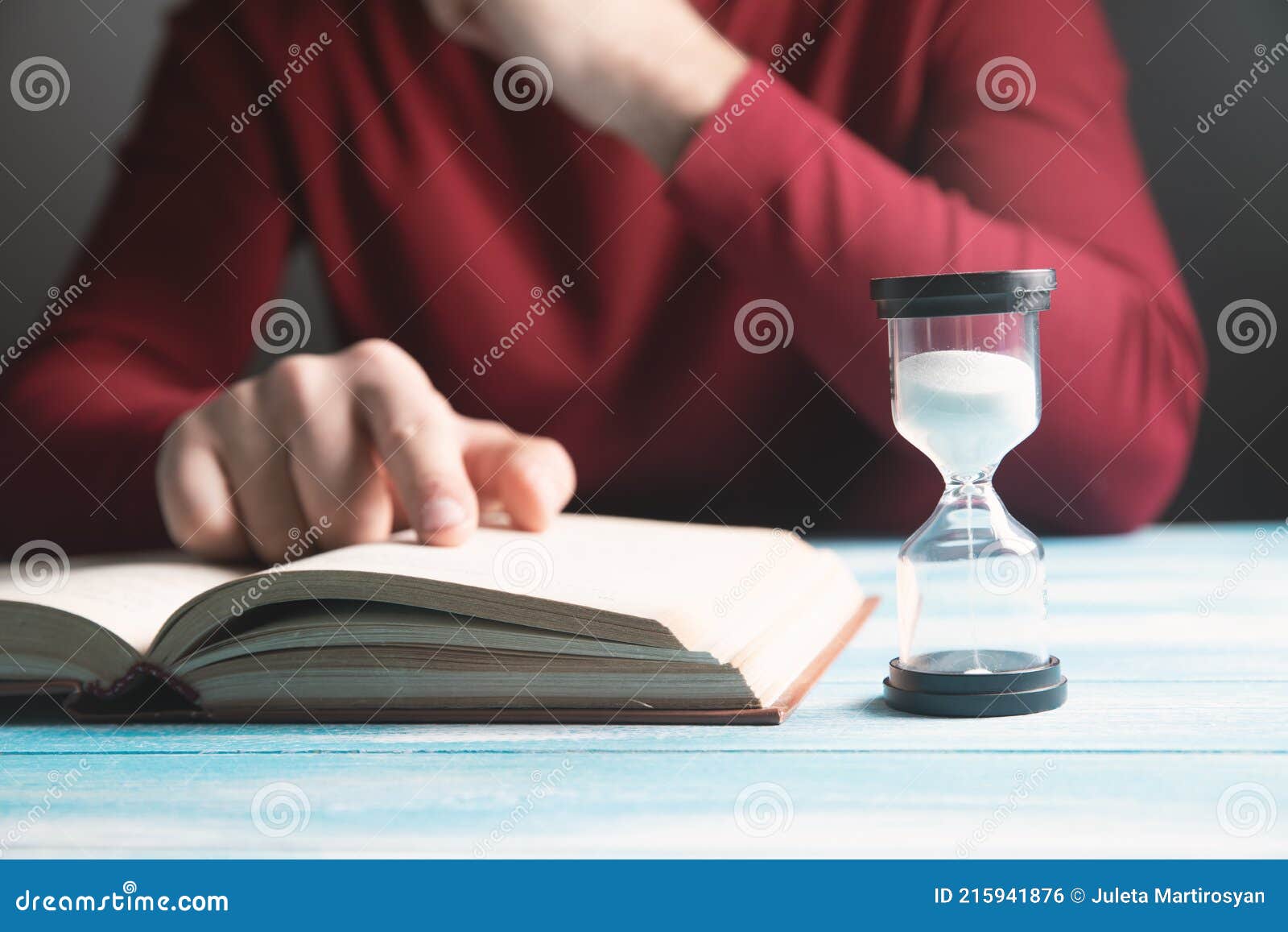 Reading a Book and an Hourglass on the Table Stock Photo - Image of ...