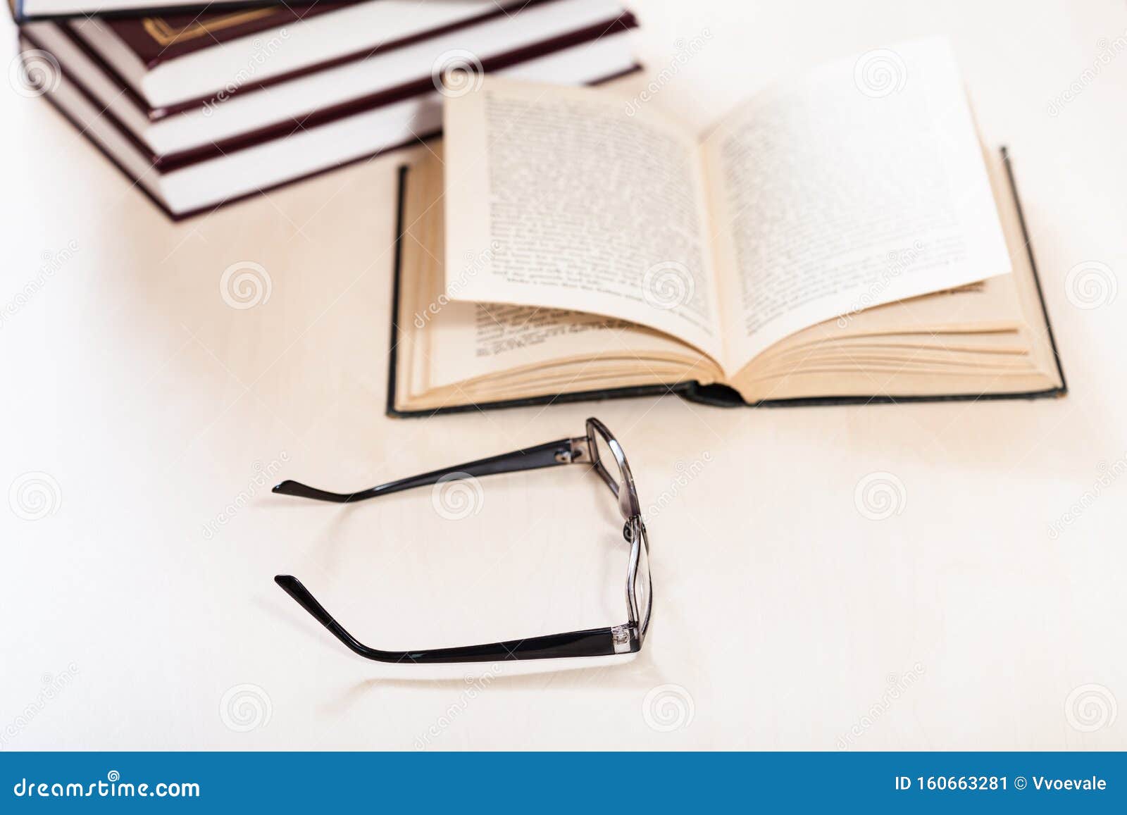 Spectacles and Open Book Near Stack of Books Stock Image - Image of ...