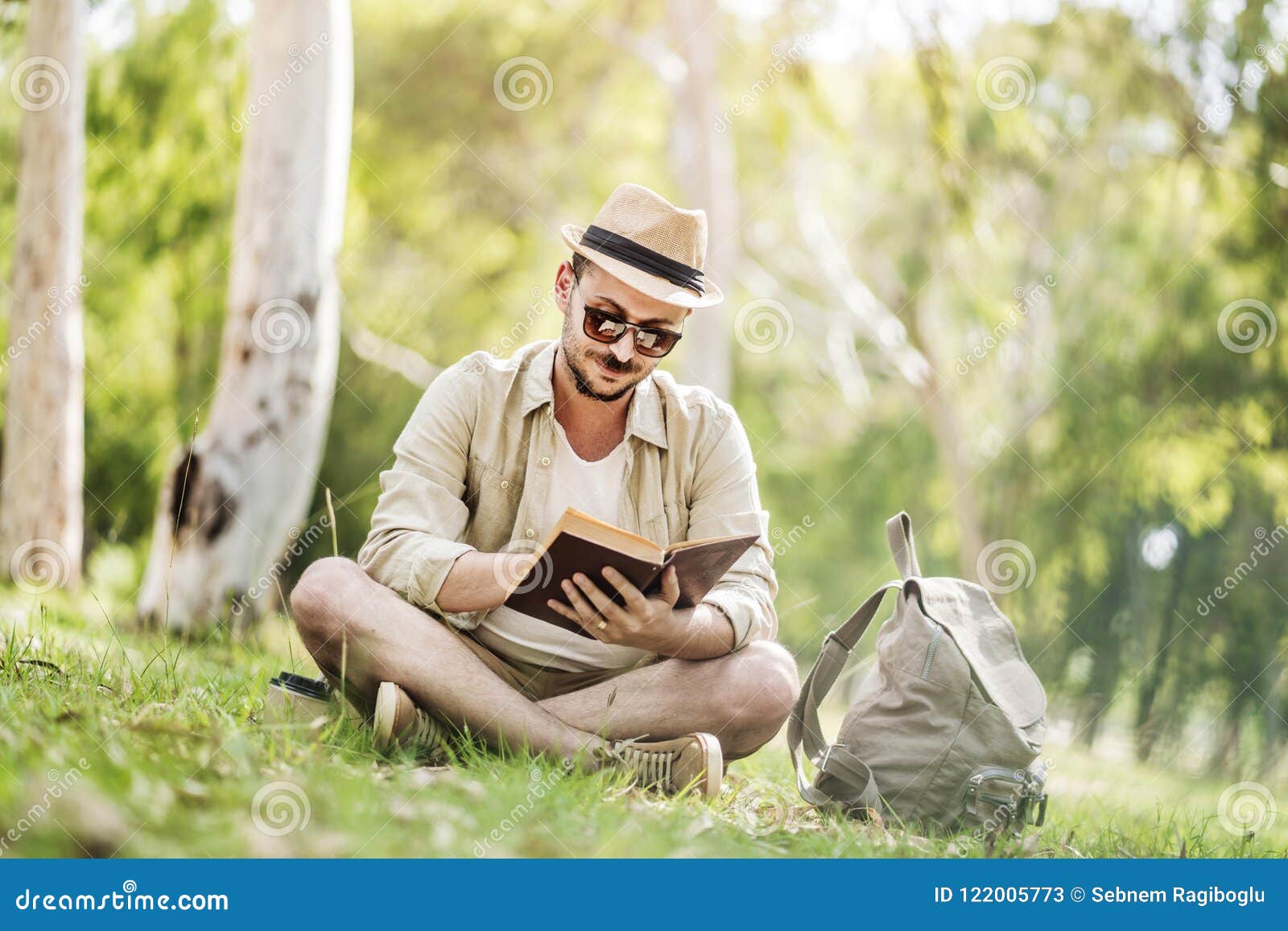 Reading a book at park stock image. Image of park, sitting - 122005773