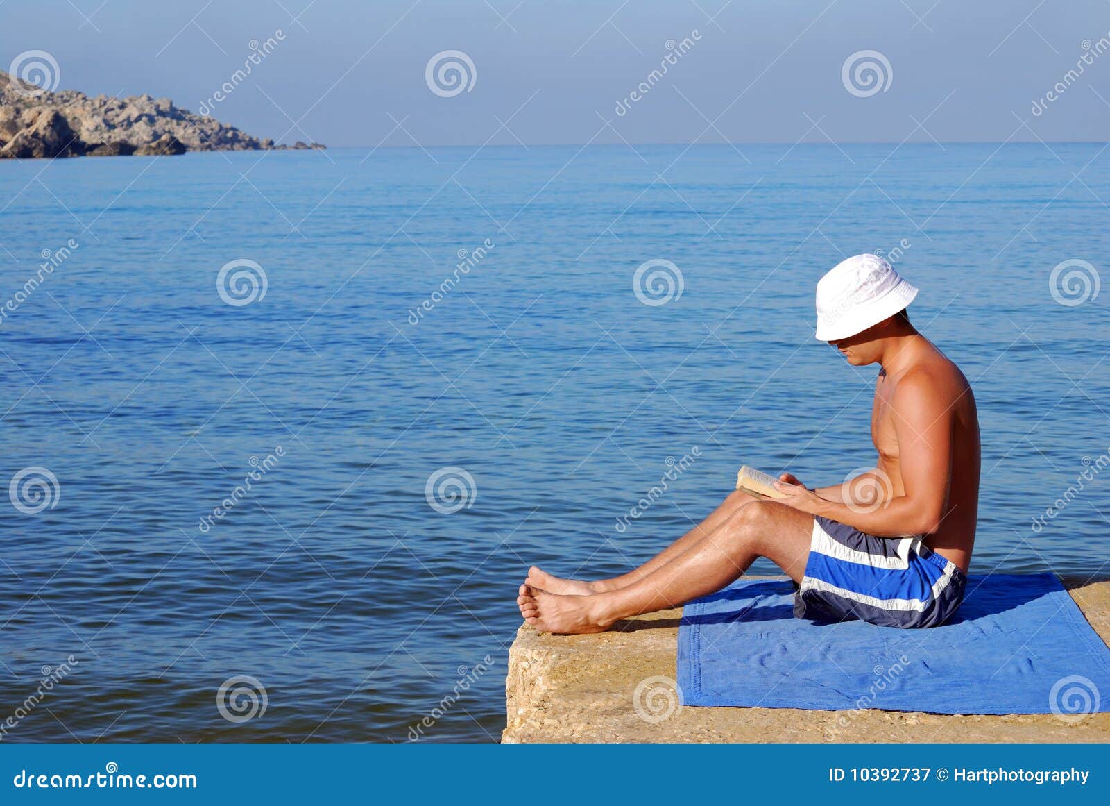 Reading book by the sea stock image. Image of suntan - 10392737