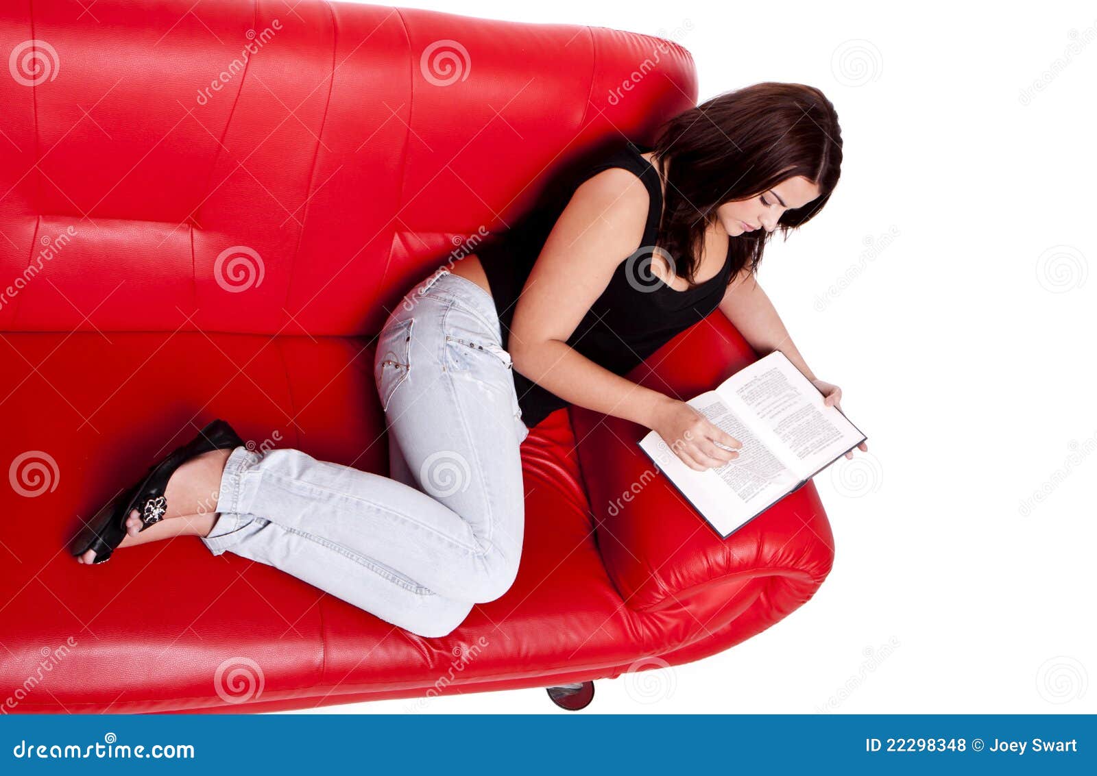 Reading a book on a sofa. stock photo. Image of elegant - 22298348