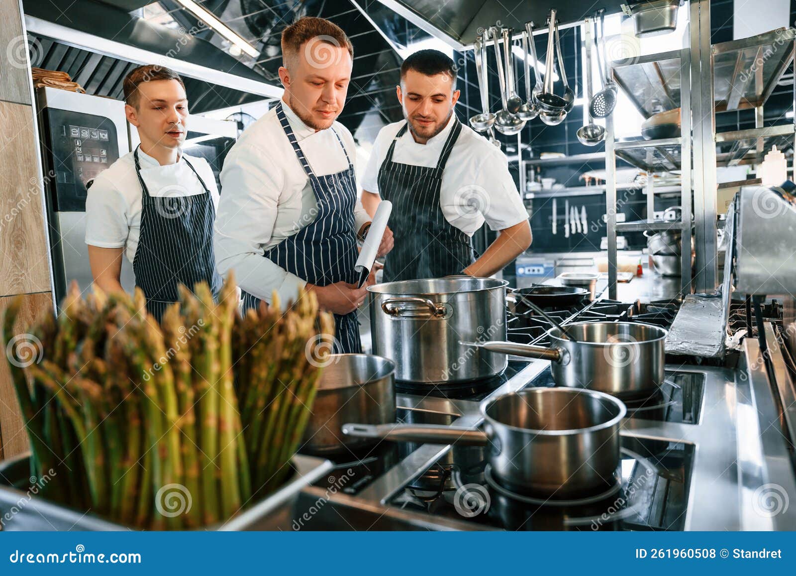 Reading the Documents. Kitchen Workers is Together Preparing the Food ...