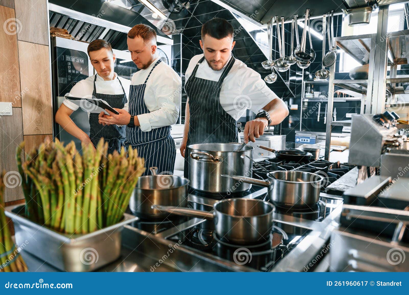 Reading the Documents. Kitchen Workers is Together Preparing the Food ...