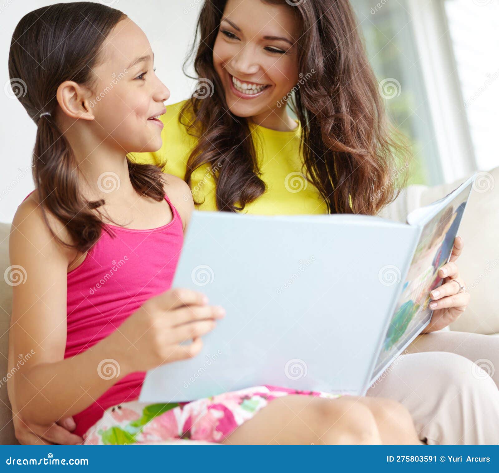 Reading Exercises the Brain. a Mother and Daughter Reading a Book ...