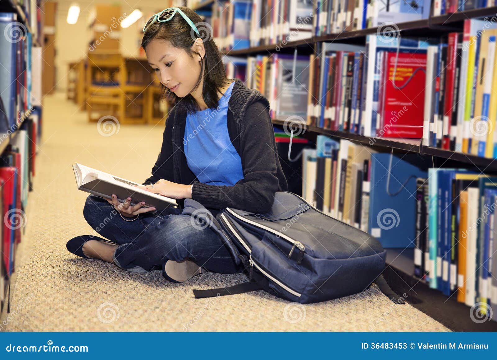 Reading in the Library stock image. Image of bookshelf - 36483453