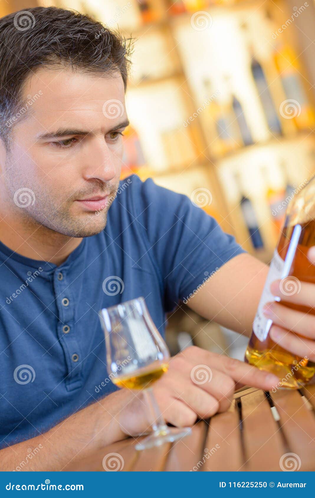 Reading a liquor label stock photo. Image of alcoholic - 116225250