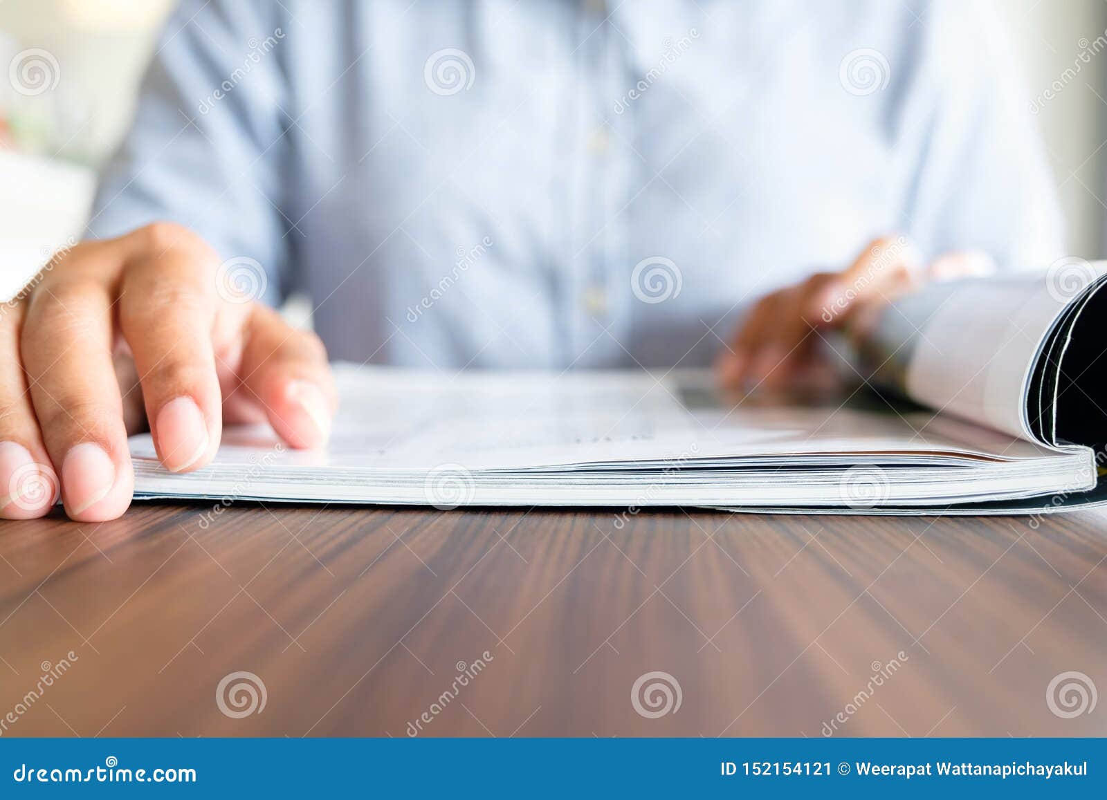 Reading Magazine on Table stock image. Image of fold - 152154121
