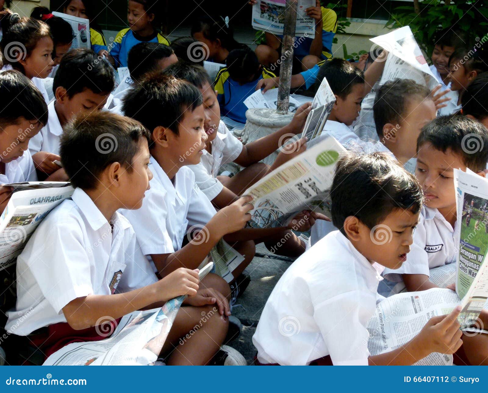 Reading a newspaper editorial photography. Image of school - 66407112