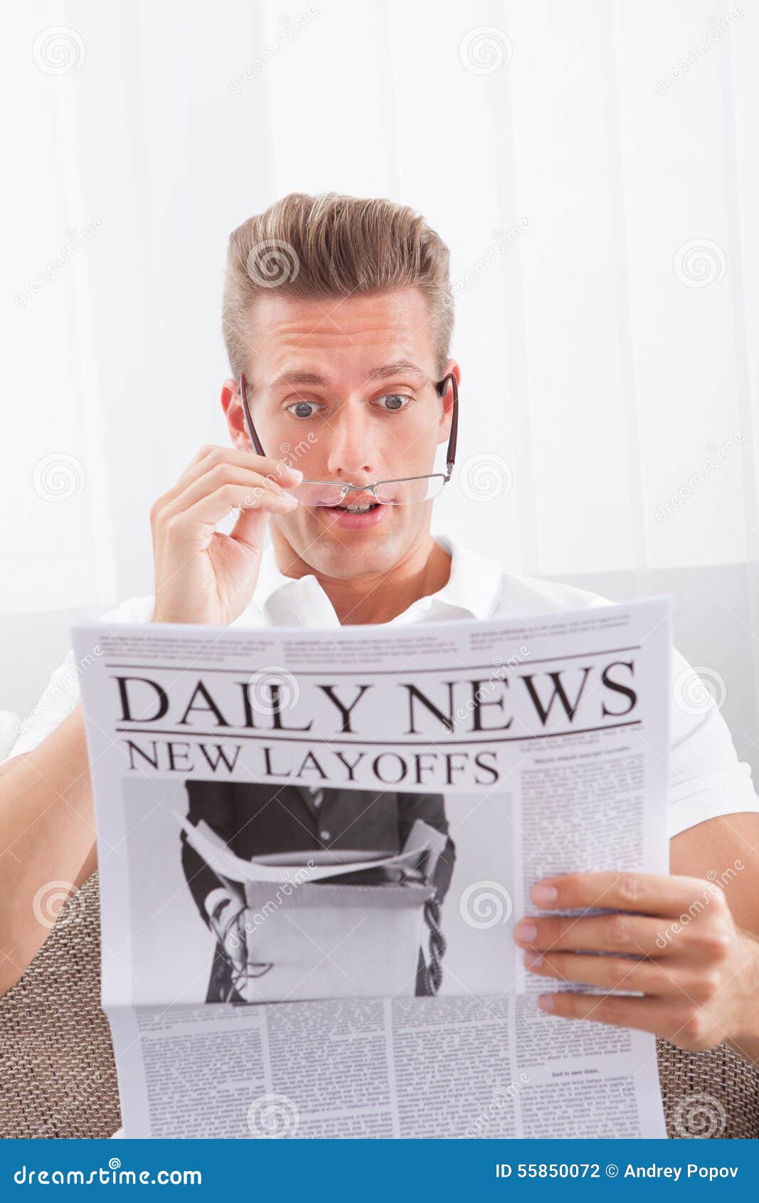 Reading Newspaper with the Headline New Layoffs Stock Photo - Image of ...