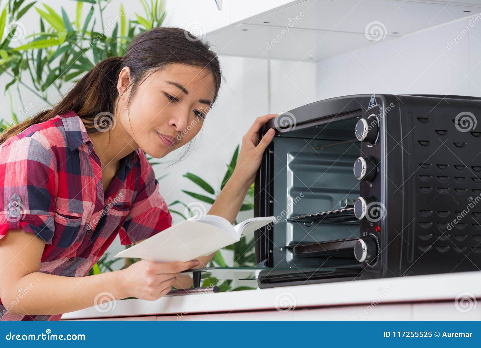 Reading the oven manual stock image. Image of adjustment - 117255525