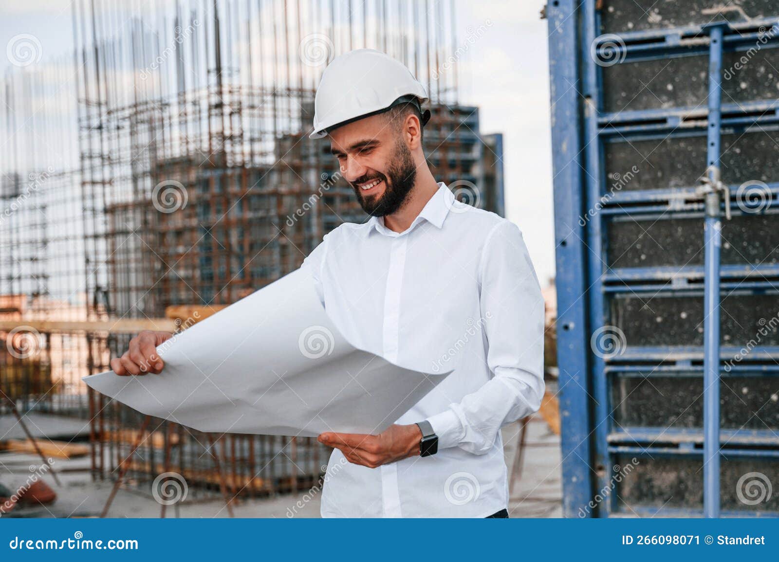Reading the Plan. Man in Uniform is Working on the Construction Site ...