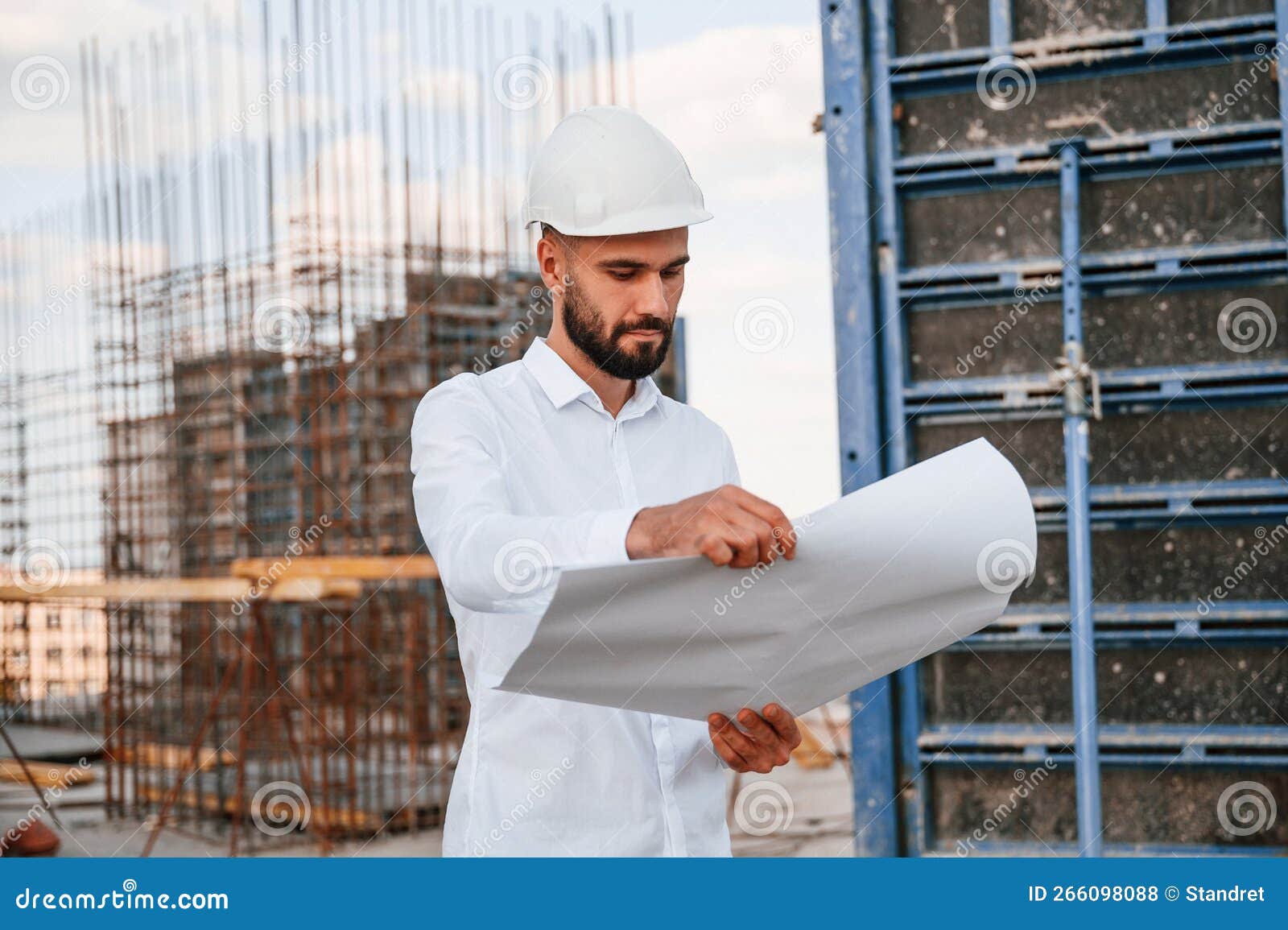 Reading the Plan. Man in Uniform is Working on the Construction Site ...