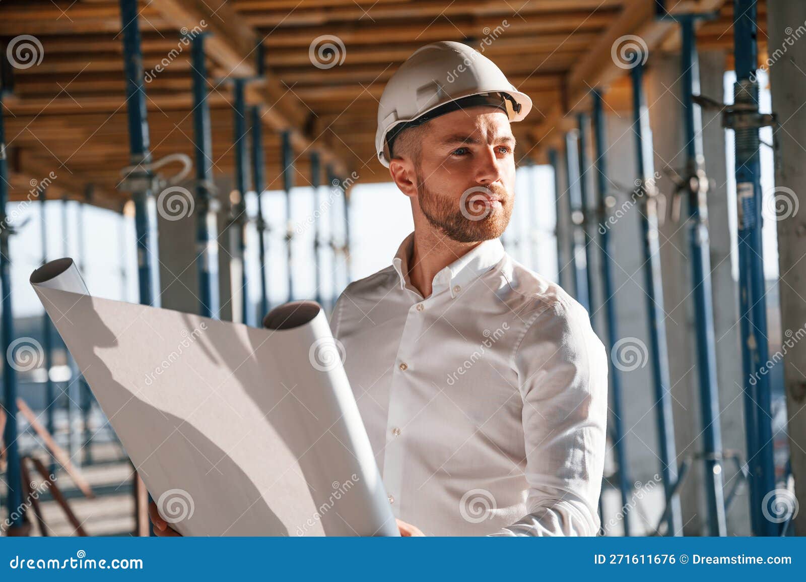 Reading the Plan. Man is Working on the Construction Site at Daytime ...