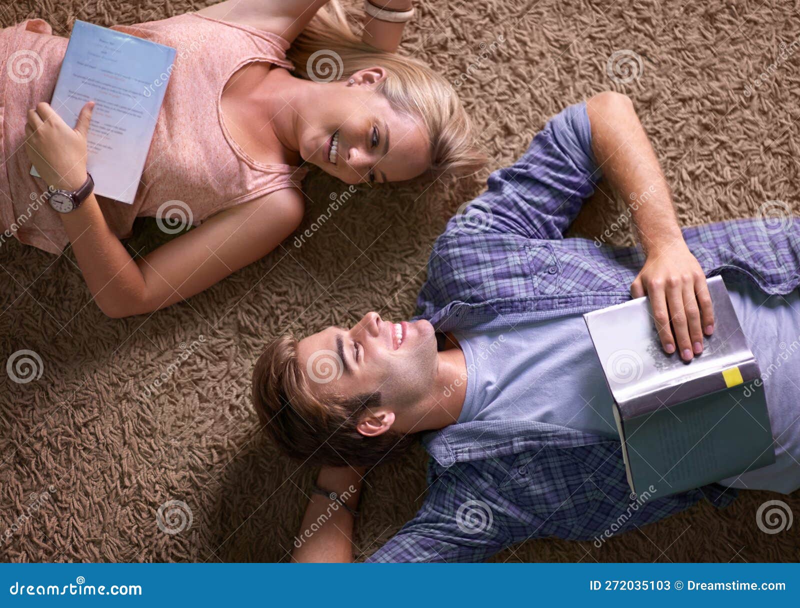 Reading while Relaxed. Two College Students Lying on the Floor Reading ...