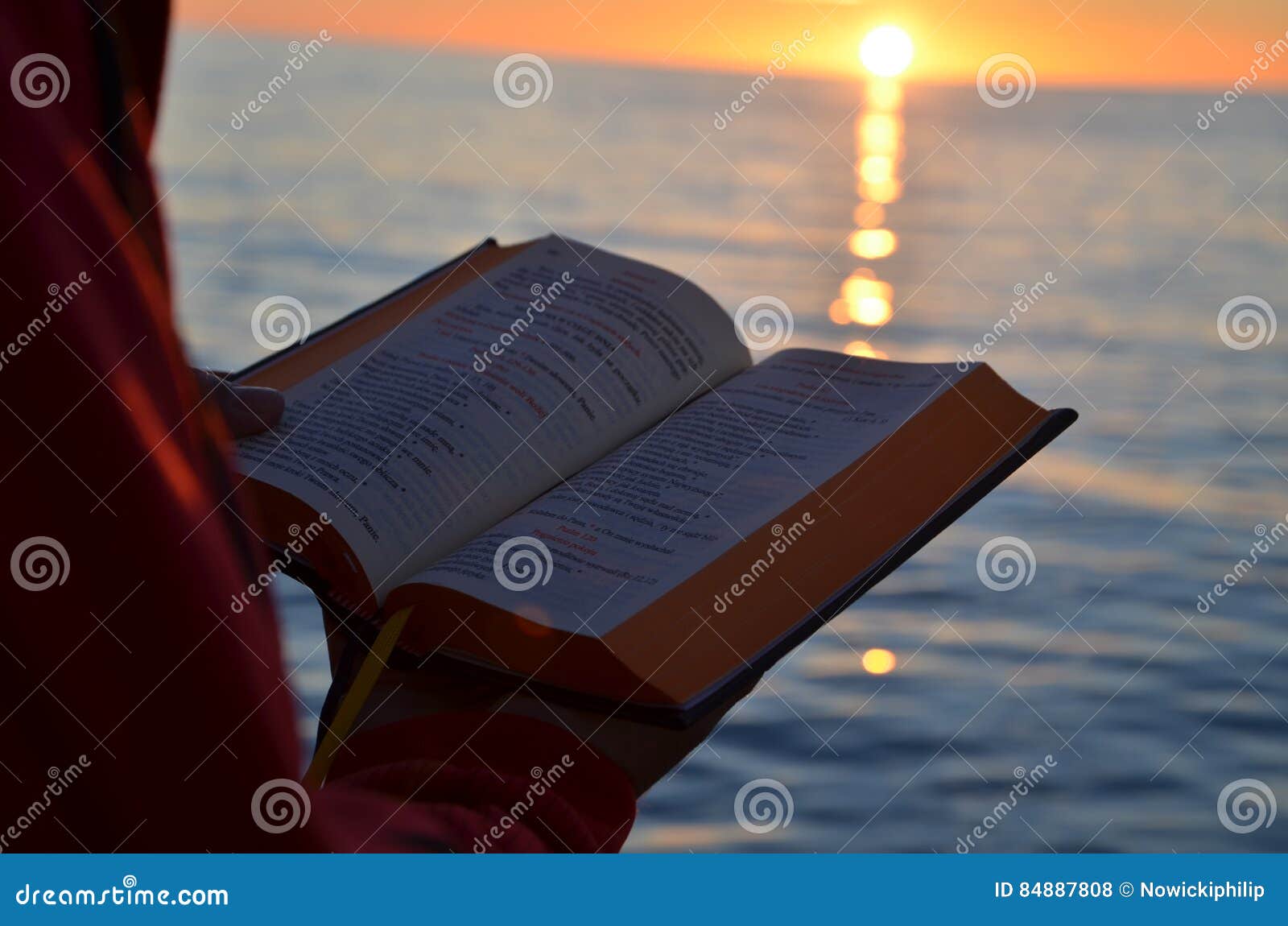 Reading during Sunset on the Baltic Sea Stock Photo - Image of grey ...