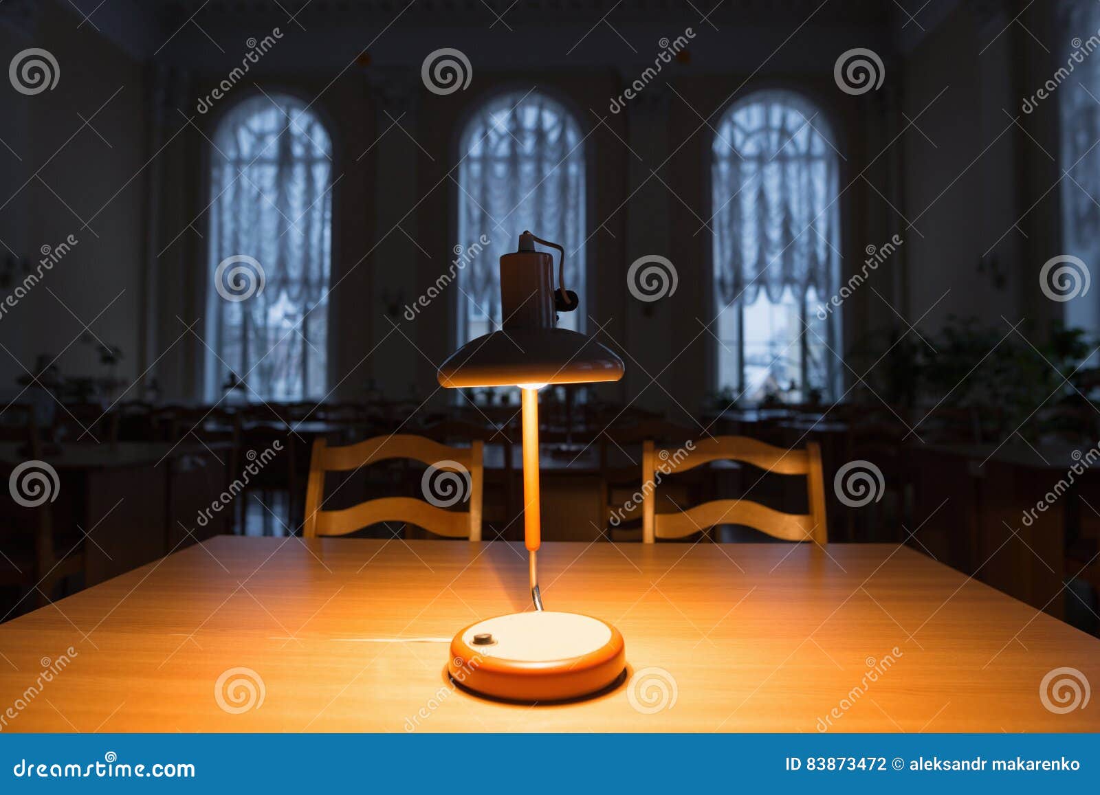 Reading at the Table with a Lamp in the Library Stock Photo - Image of ...