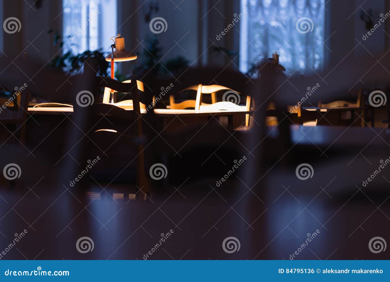 Reading at the Table with a Lamp in the Library Stock Photo - Image of ...