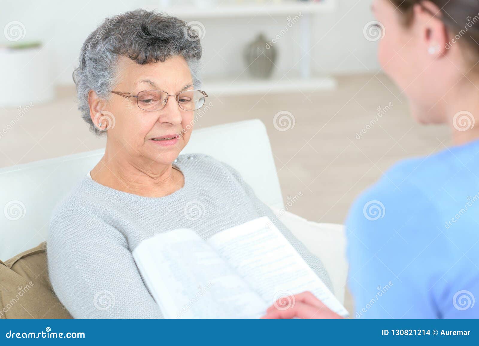 Reading to elderly person stock photo. Image of homhelp - 130821214