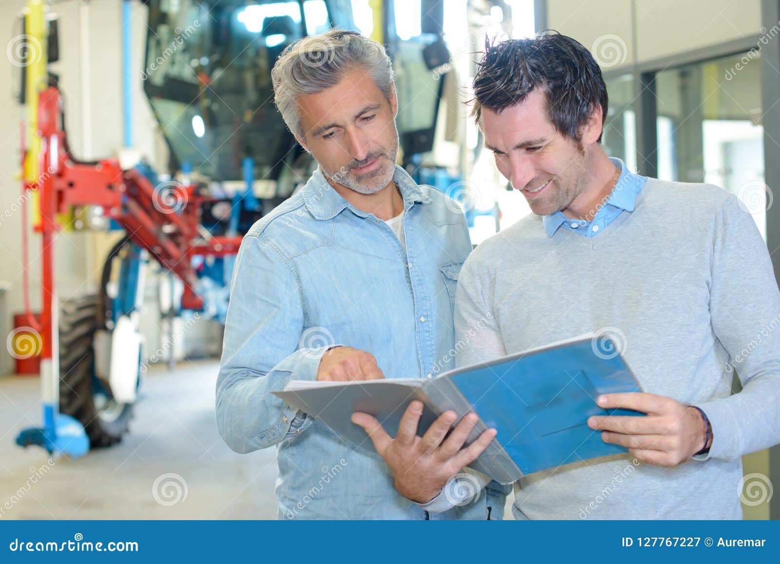 Reading the tractor manual stock image. Image of merchandiser - 127767227